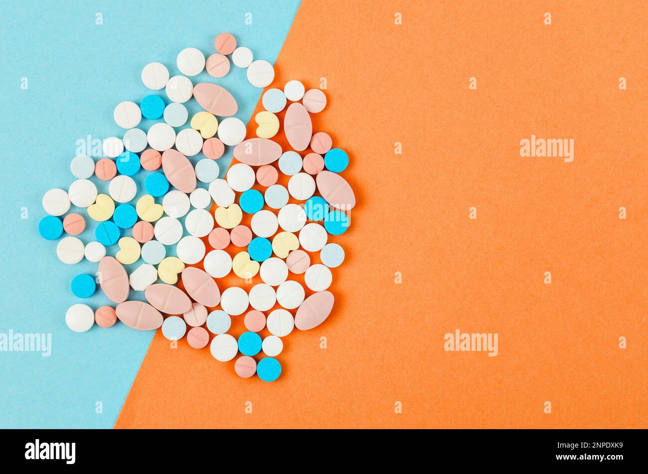 A heap of different medicinal drugs, tablets and pills on blue ...