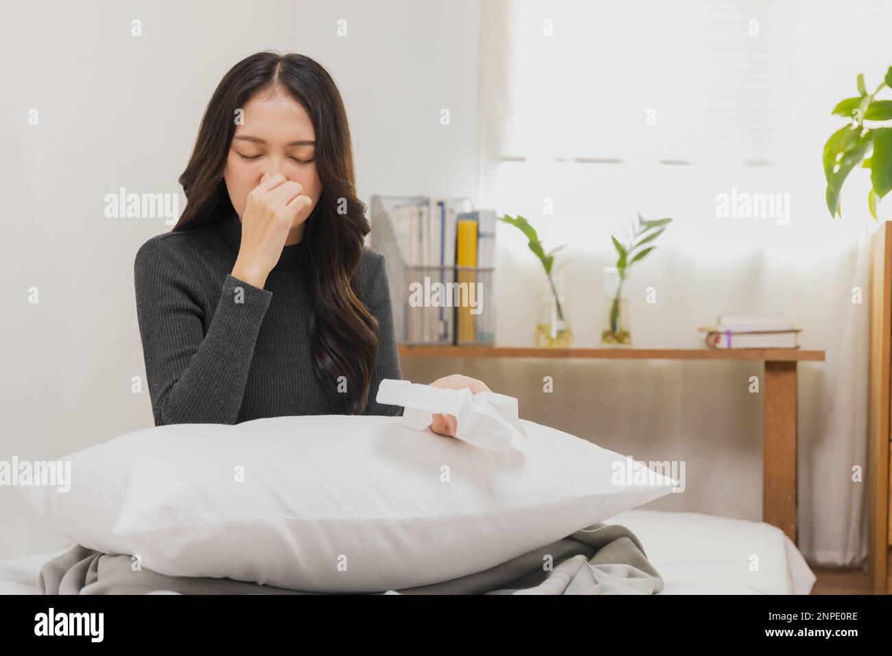 Asian woman has fever and bad cold in bedroom Stock Photo - Alamy