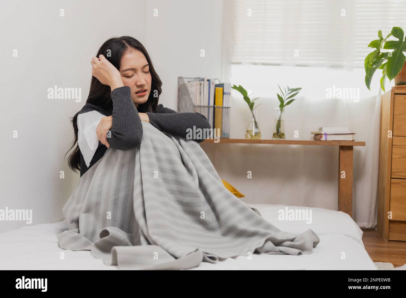 Asian woman has fever and bad cold in bedroom Stock Photo - Alamy