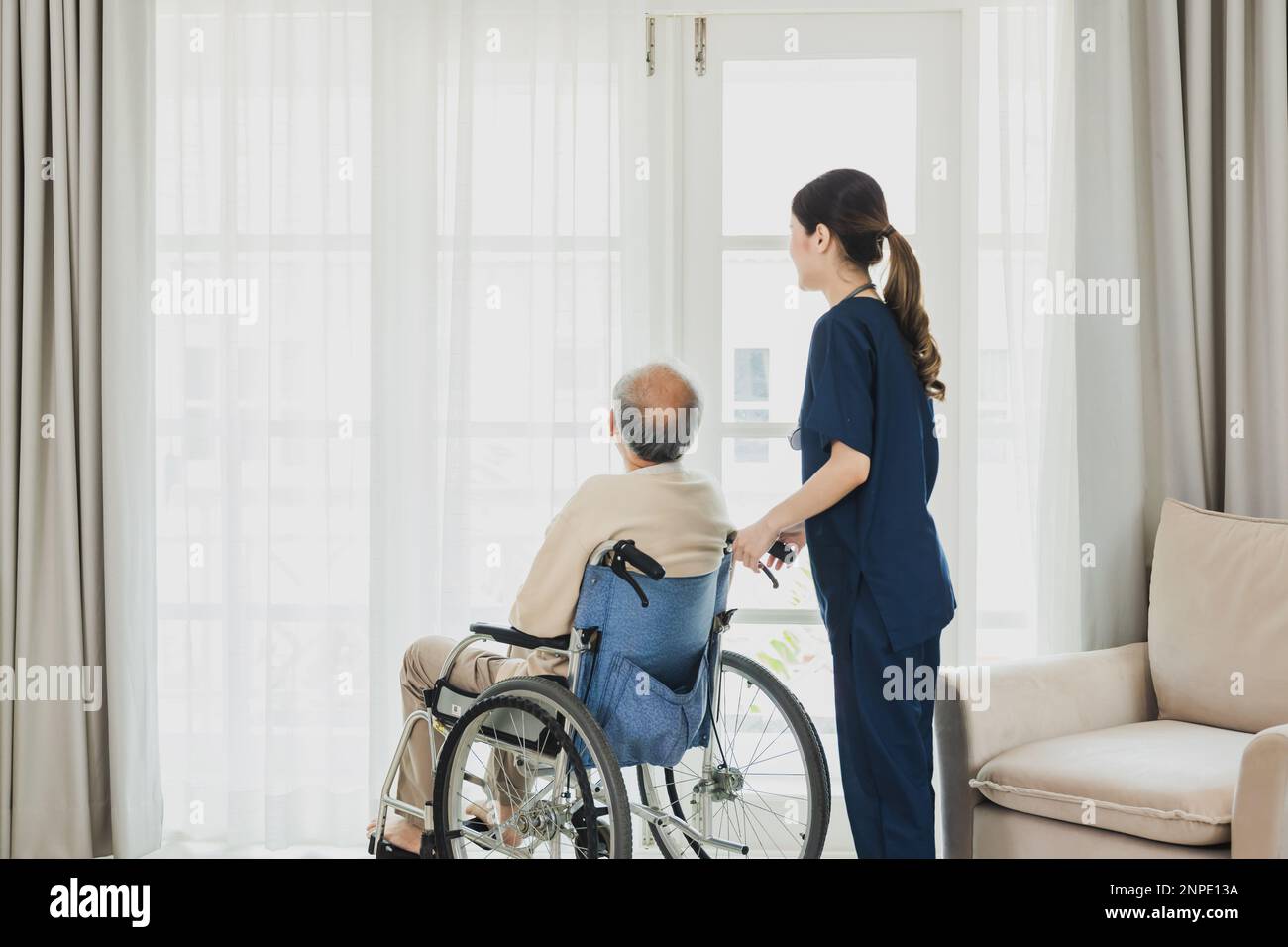Senior man in wheelchair receives medical help for injury Stock Photo ...