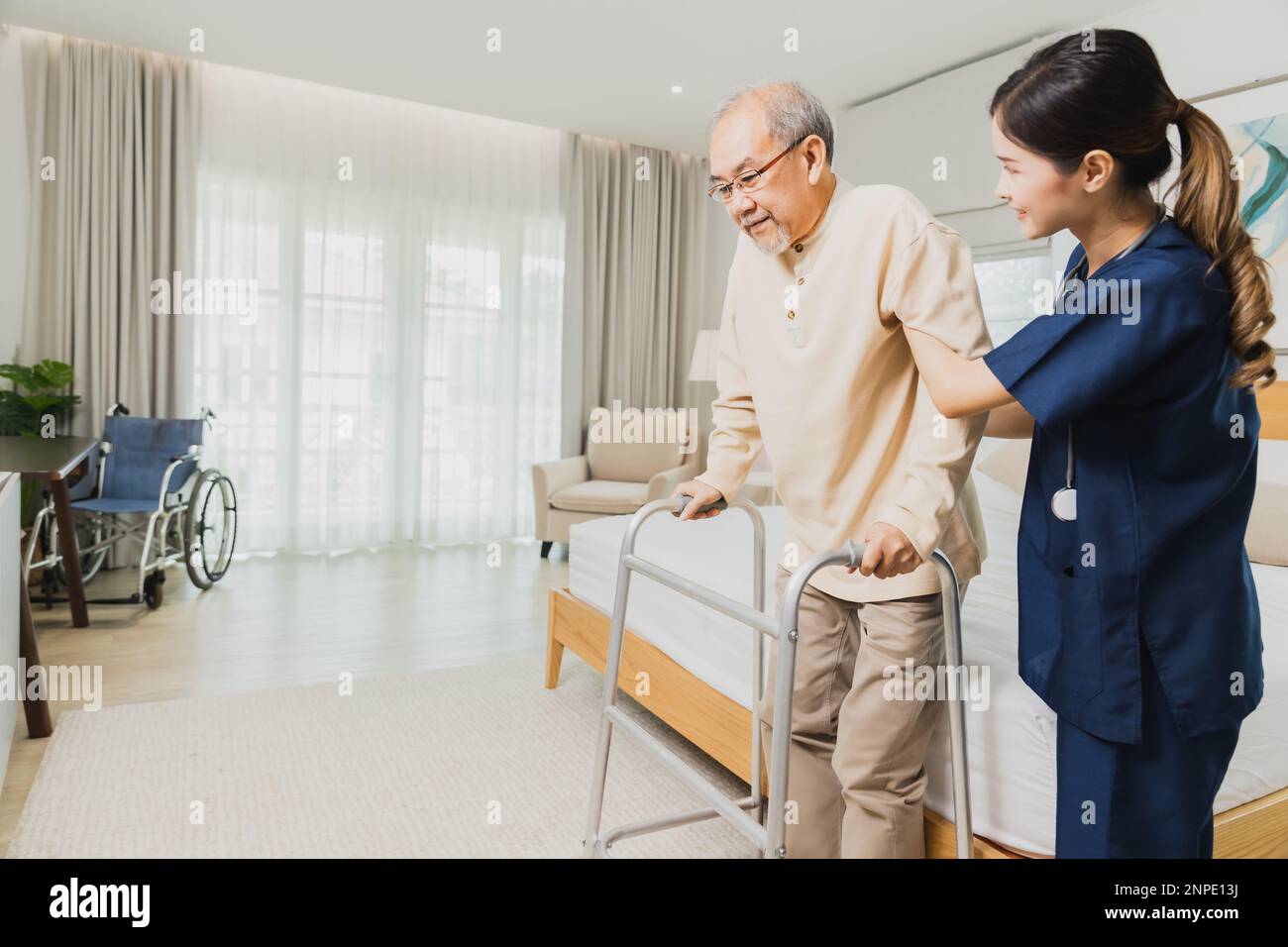 Elderly patient physiotherapy nurse exercising and try to walk Stock ...