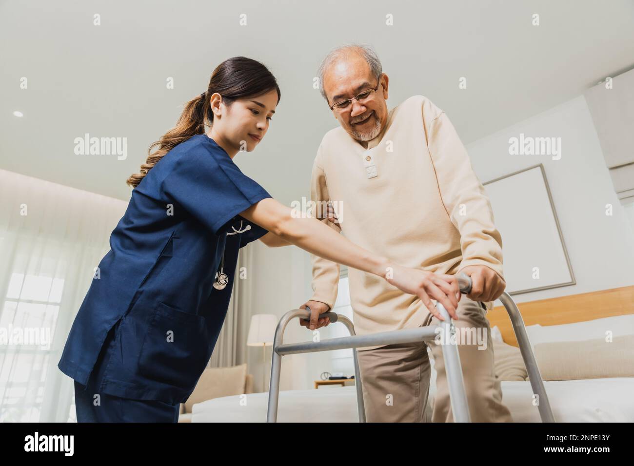 Elderly patient physiotherapy nurse exercising and try to walk Stock ...