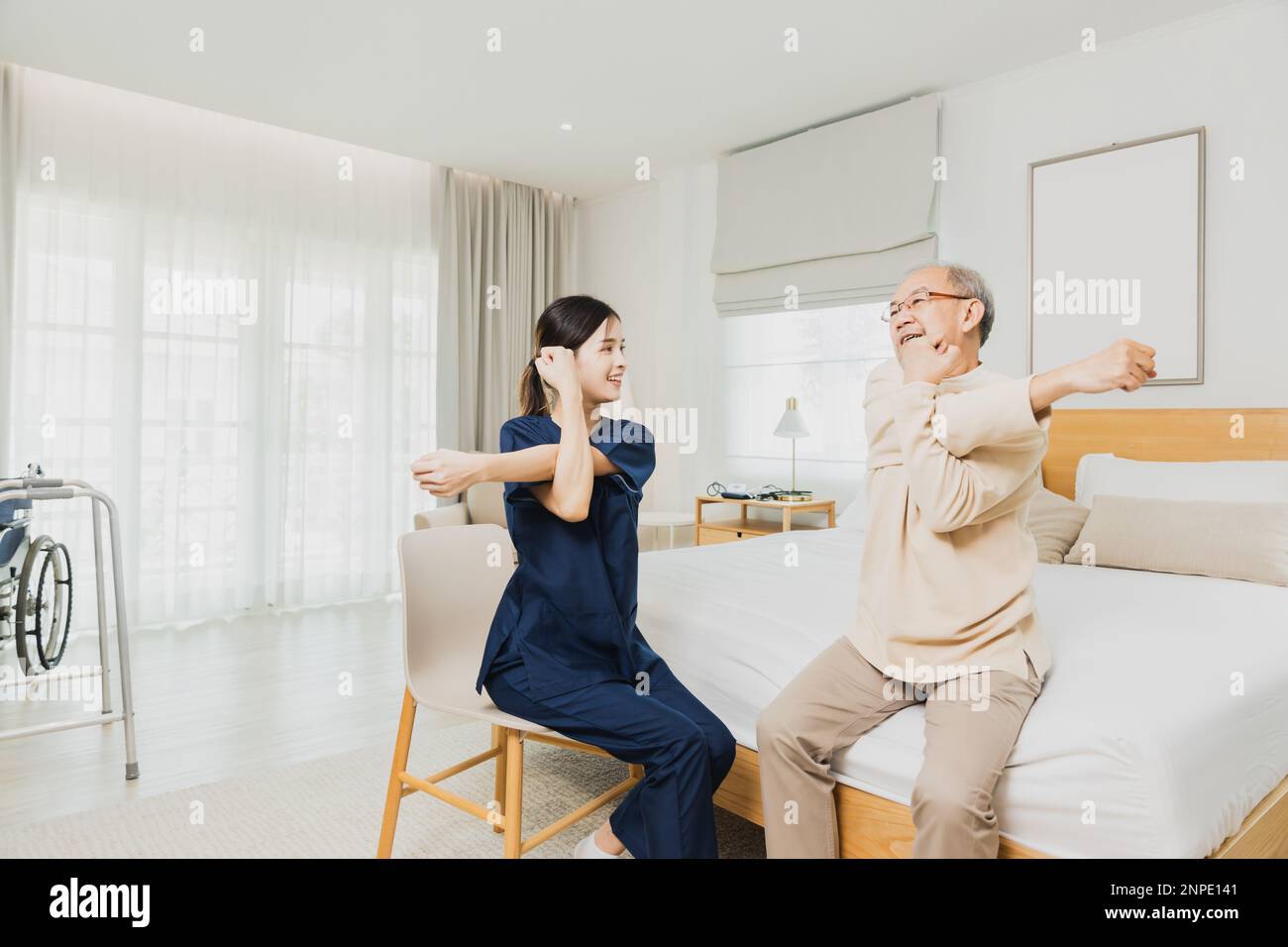 Nurse look after elderly patient exercising Stock Photo - Alamy