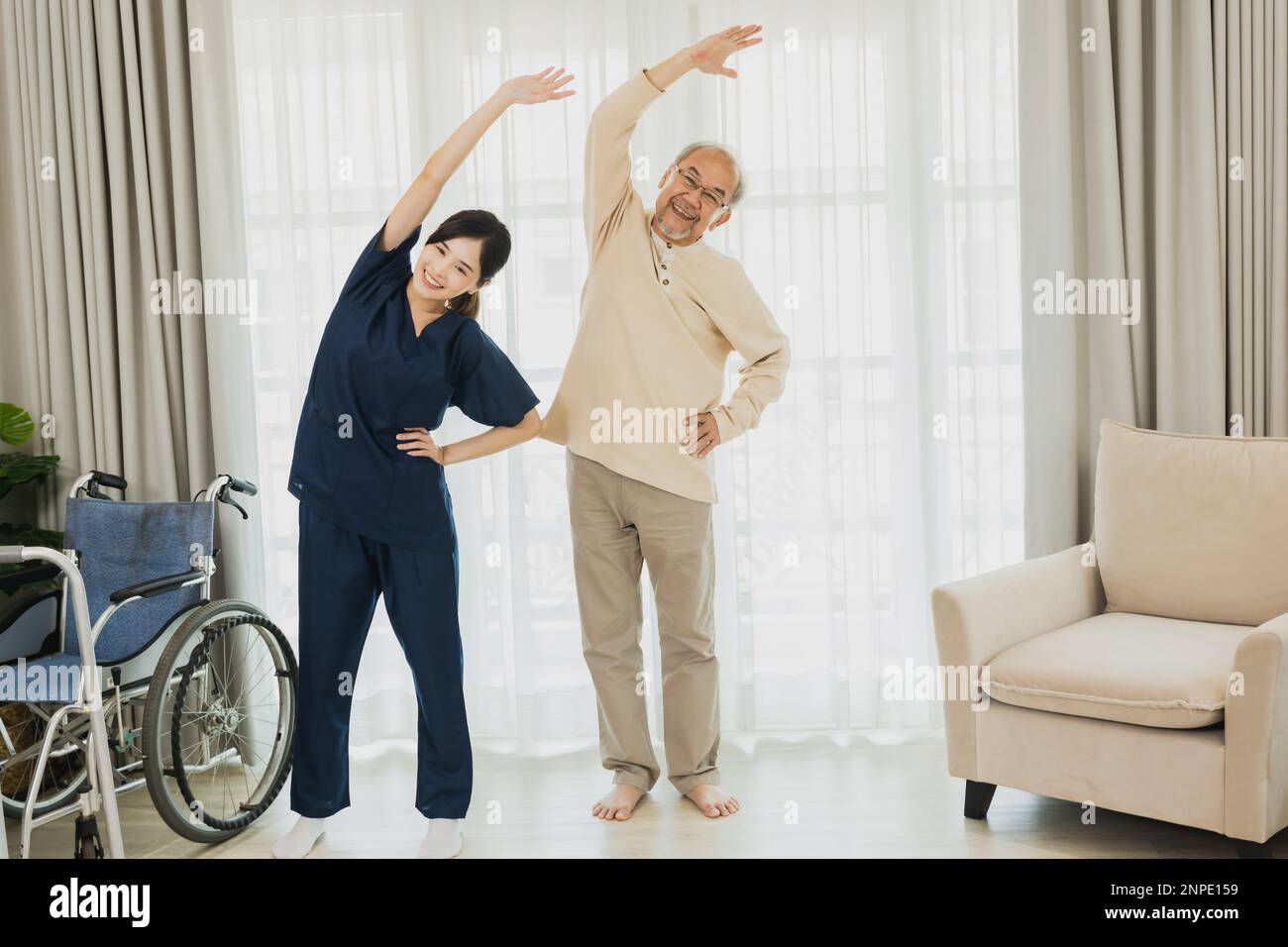 Nurse look after elderly patient exercising Stock Photo - Alamy