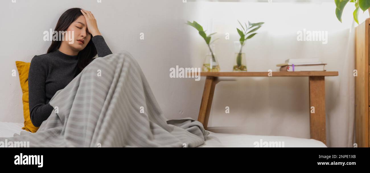 Asian woman has fever and bad cold in bedroom Stock Photo - Alamy