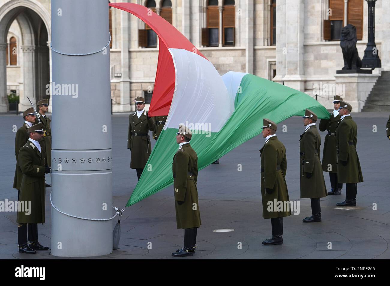 The Hungarian national flag is hoisted then lowered to half-mast by honour guards during the ...