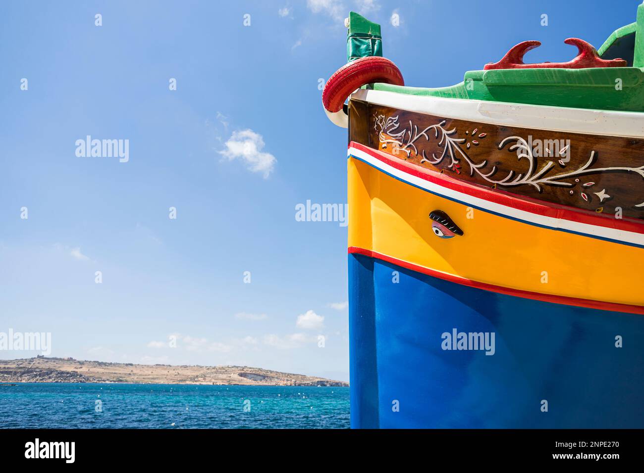 Luzzu boat next to the blue water at Bugibba in Malta Stock Photo - Alamy