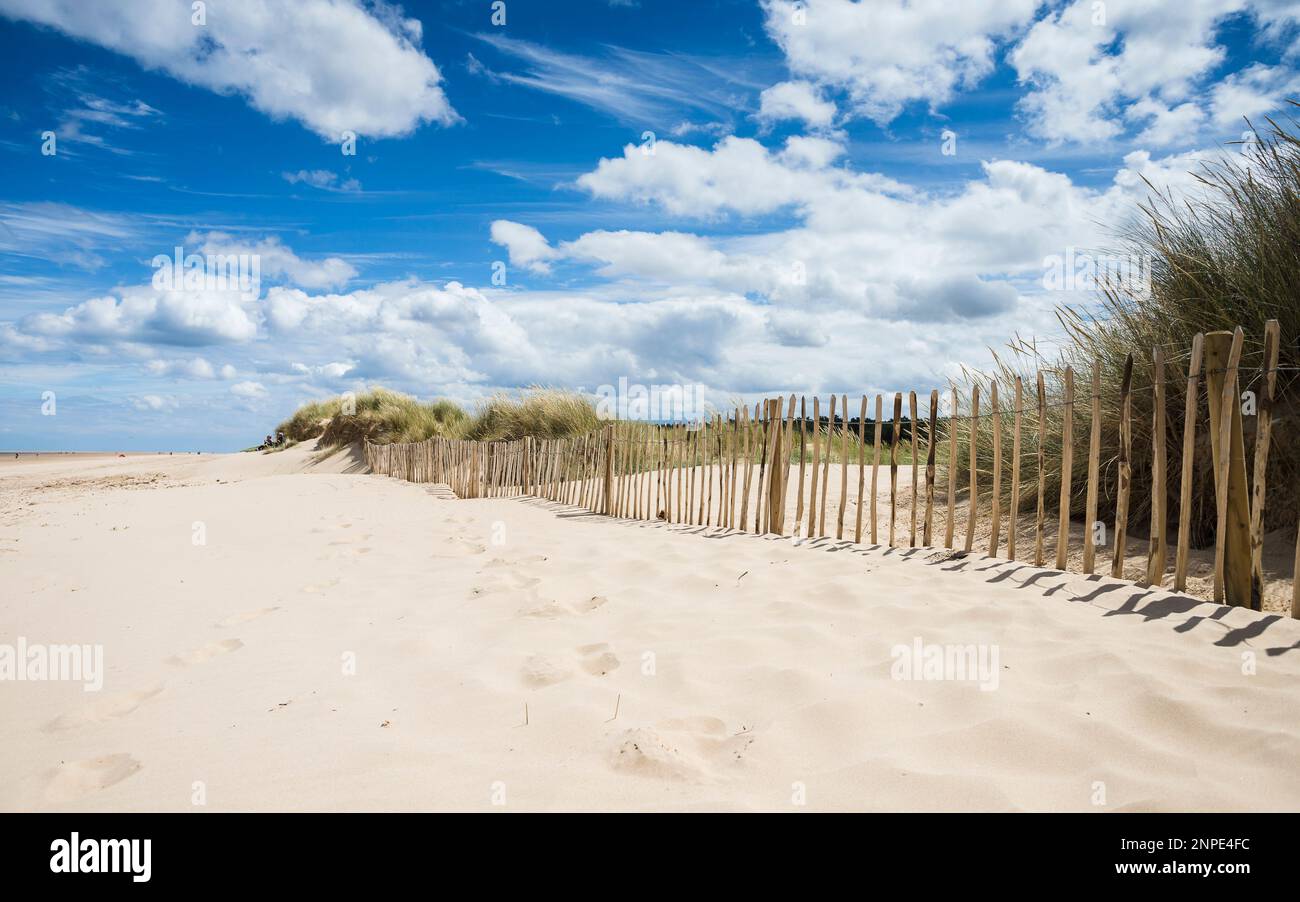 Beautiful clean sand seen next to a beach fence at Holkham on the North ...