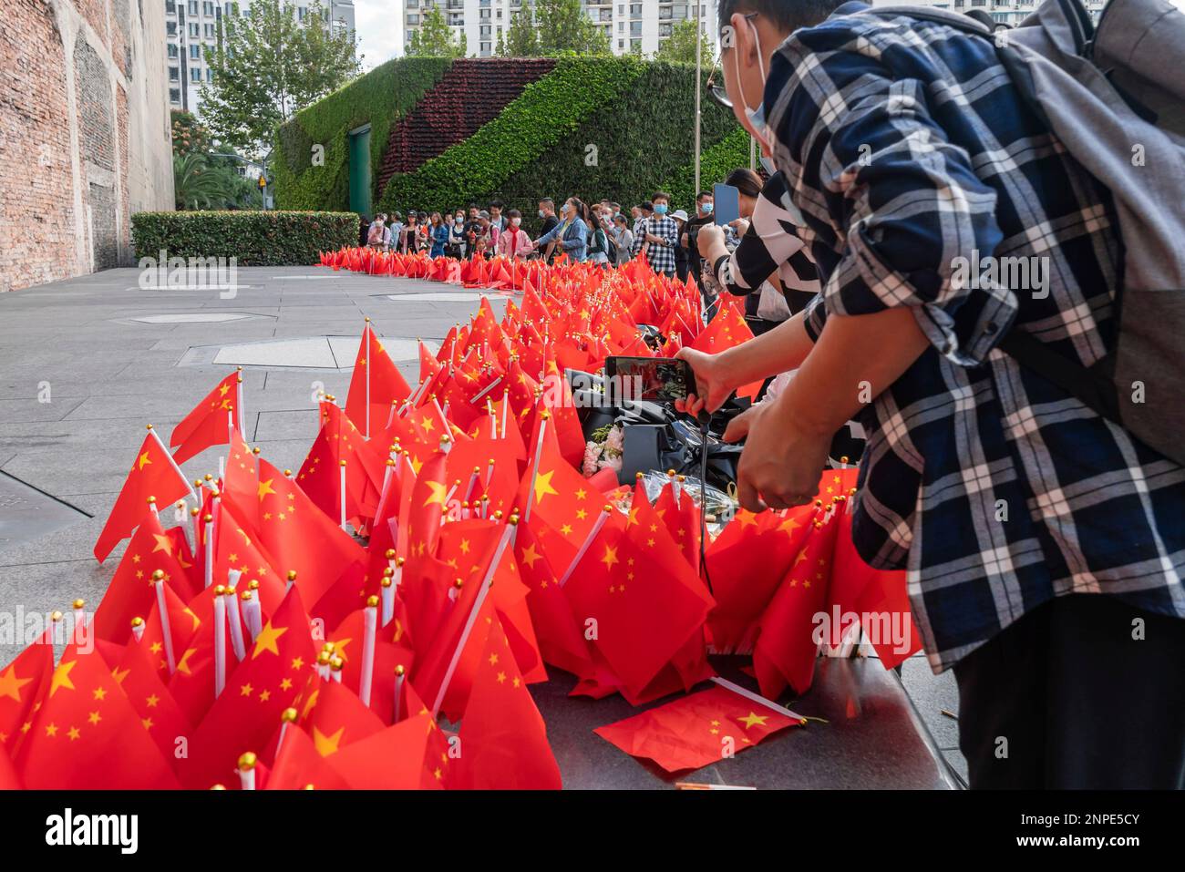 Tourists stand flags outside Sihang warehouse, which witnessed a heroic ...