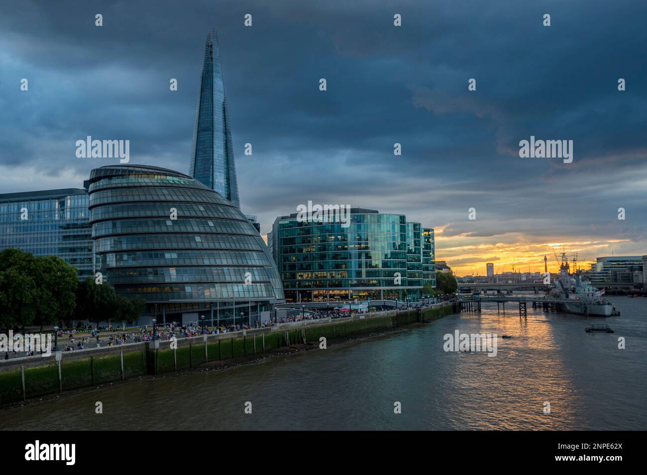 The sun sets over the city of London allowing just the River Thames to ...