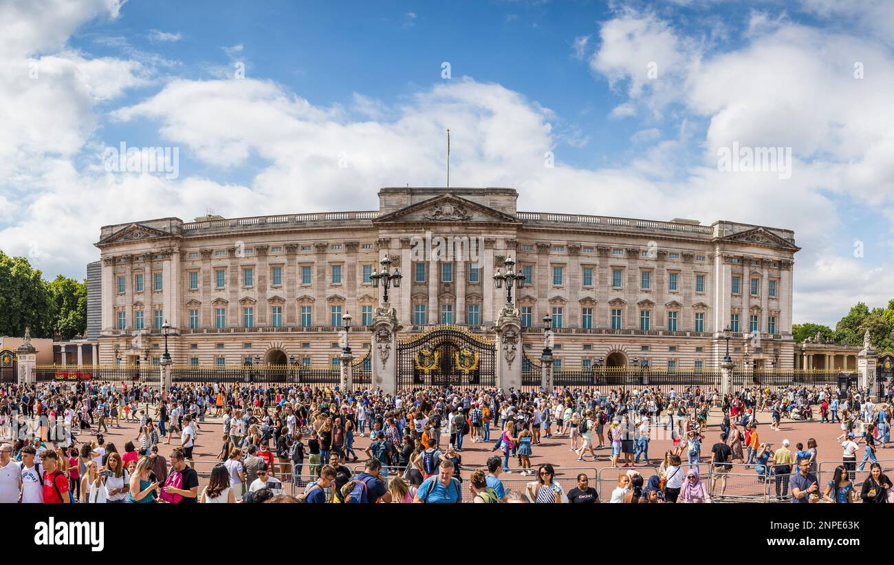 Tourists outside Buckingham Palace in London after gathering to watch the Changing of the Guard ...