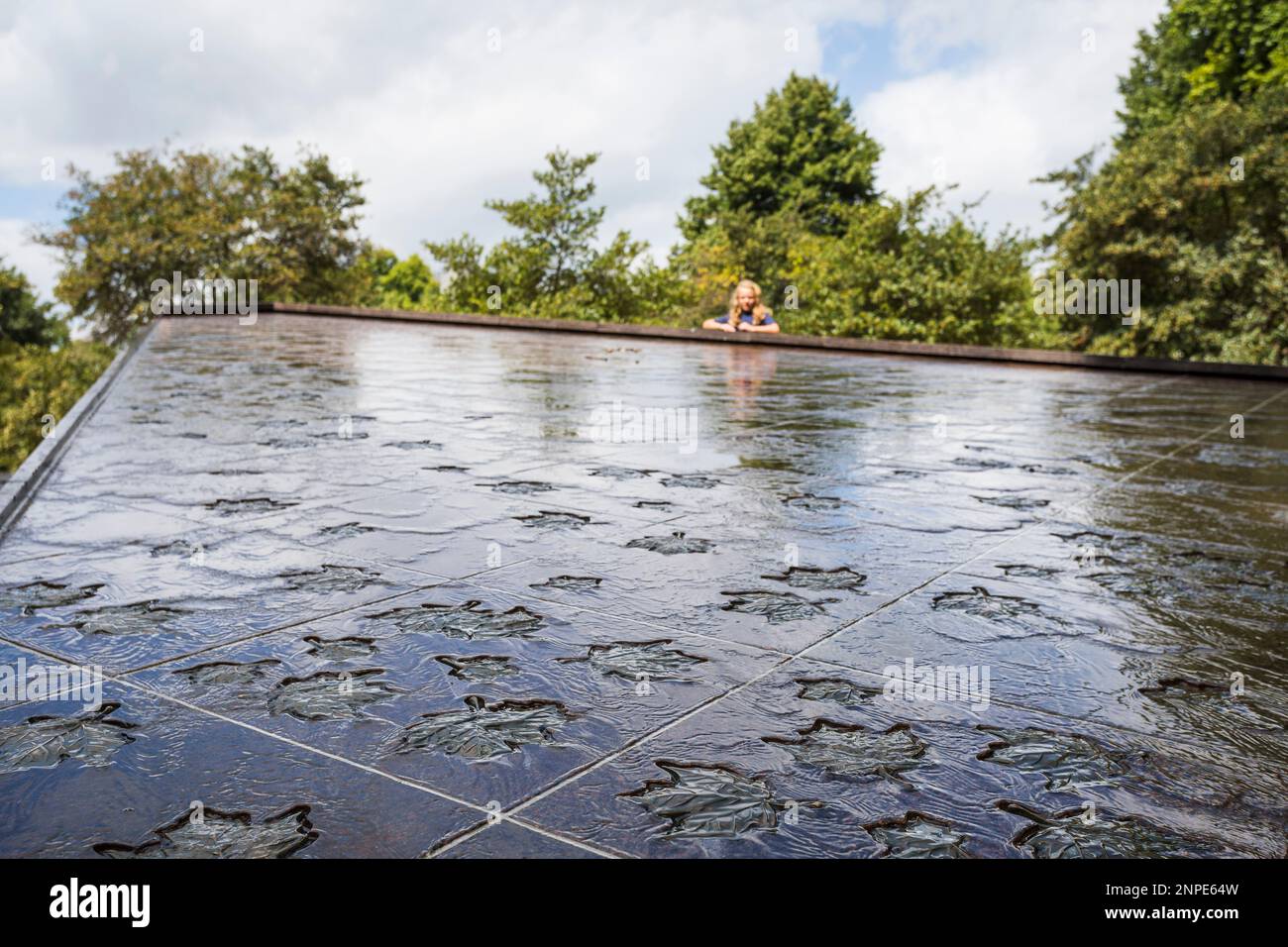 A girl overlooking the water flowing down the Canada Memorial in Green ...