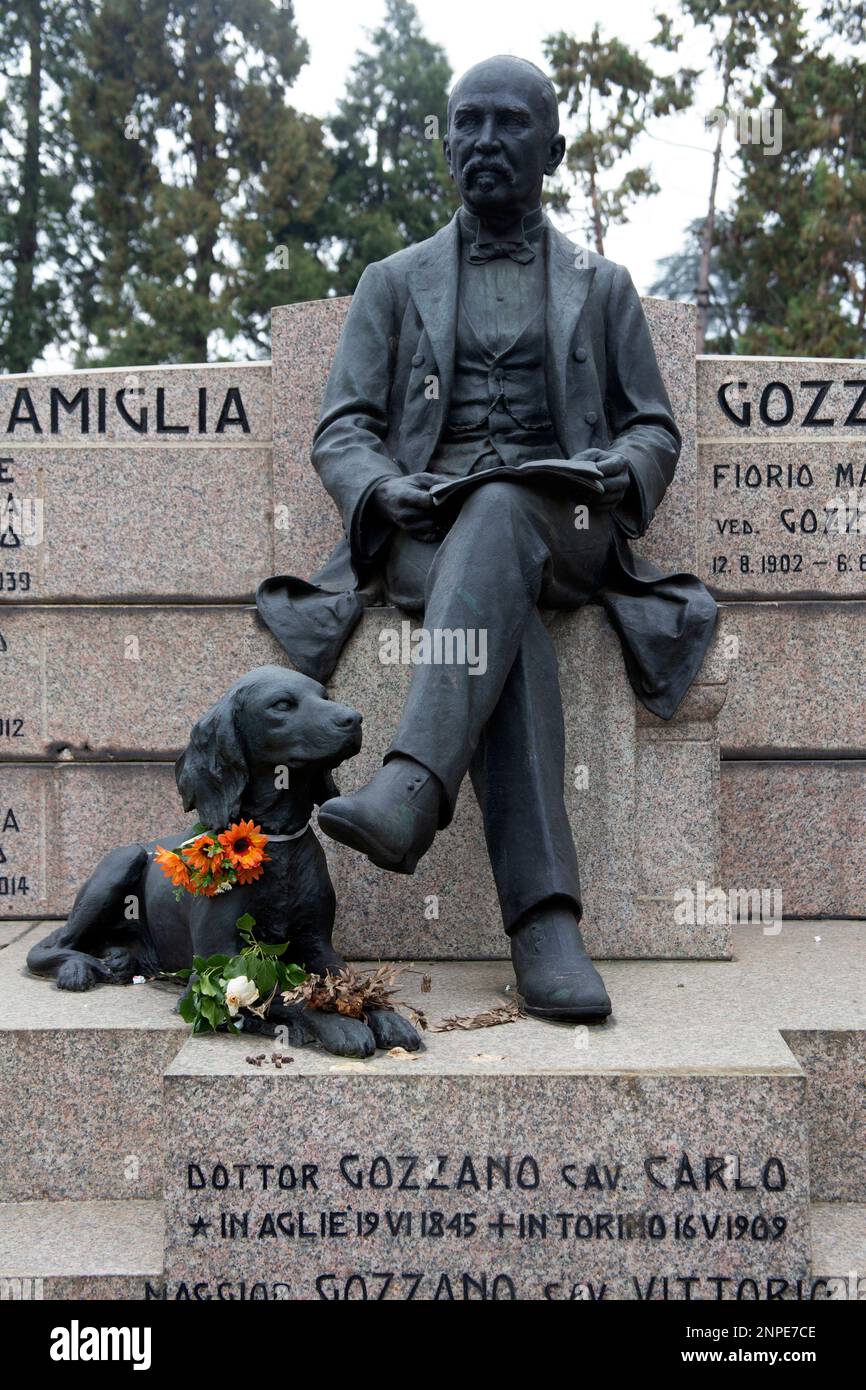 Grave of Guido Gustavo Gozzano a statue of a man sitting with a dog at ...