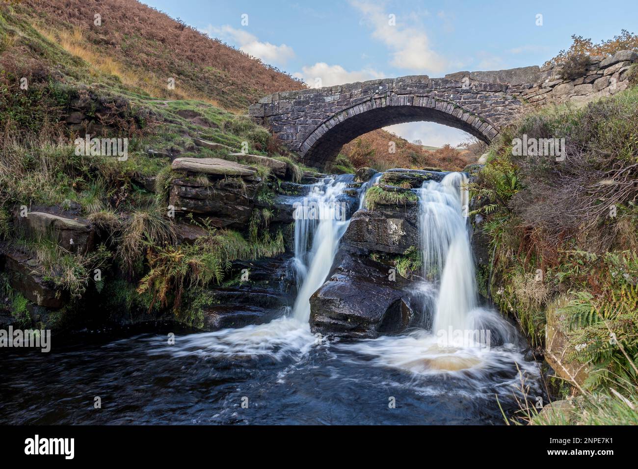 The River Dane flows under the packhorse bridge at Three Shires Head ...
