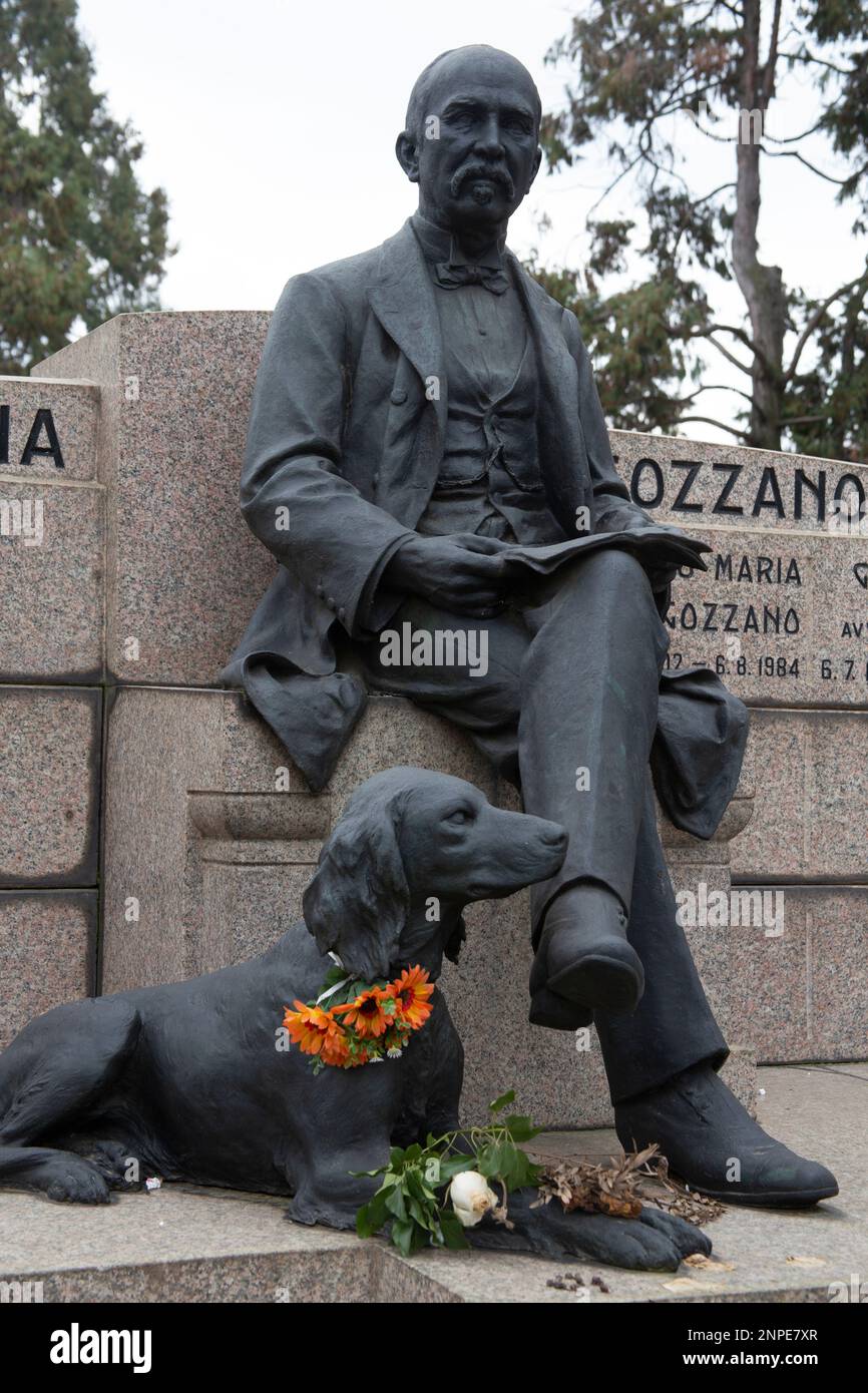 Grave of Guido Gustavo Gozzano a statue of a man sitting with a dog at ...
