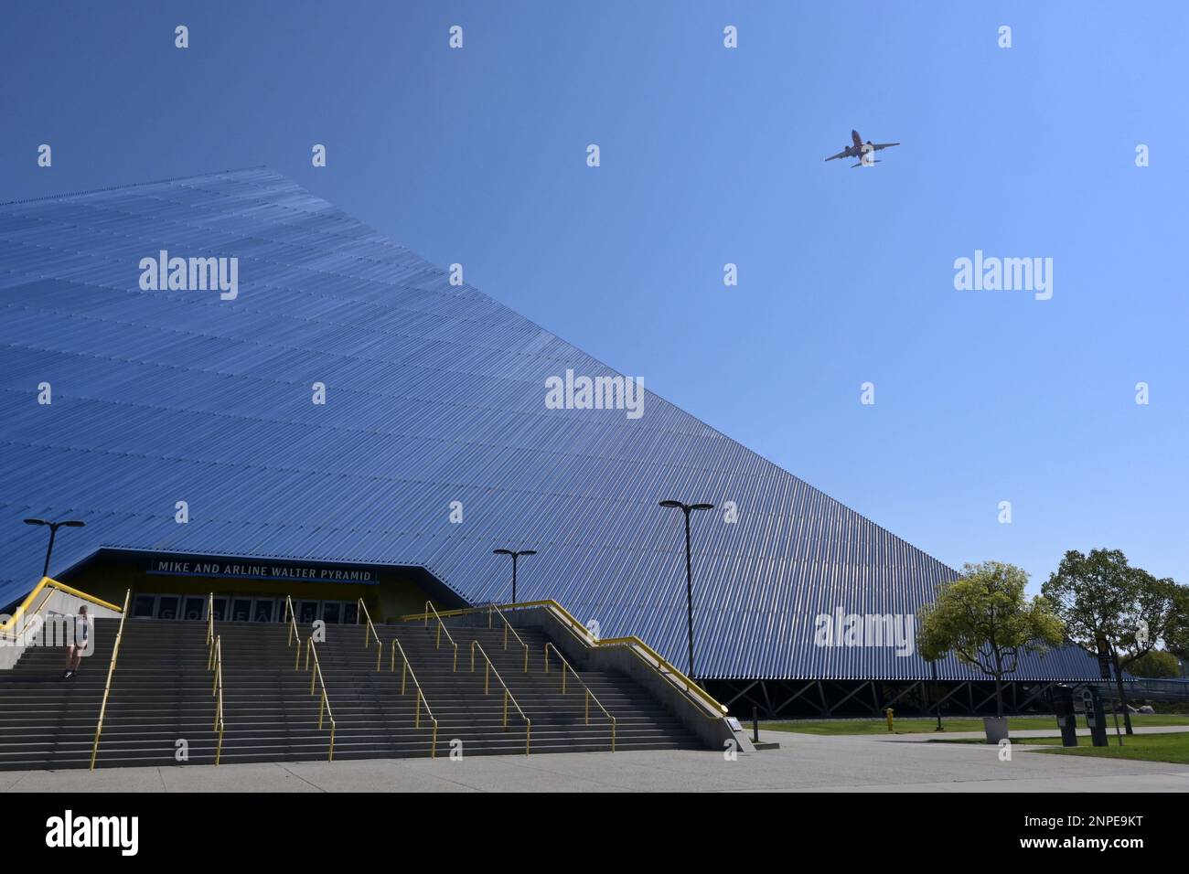 A general view of an airplane flying over the Walter Pyramid on the ...