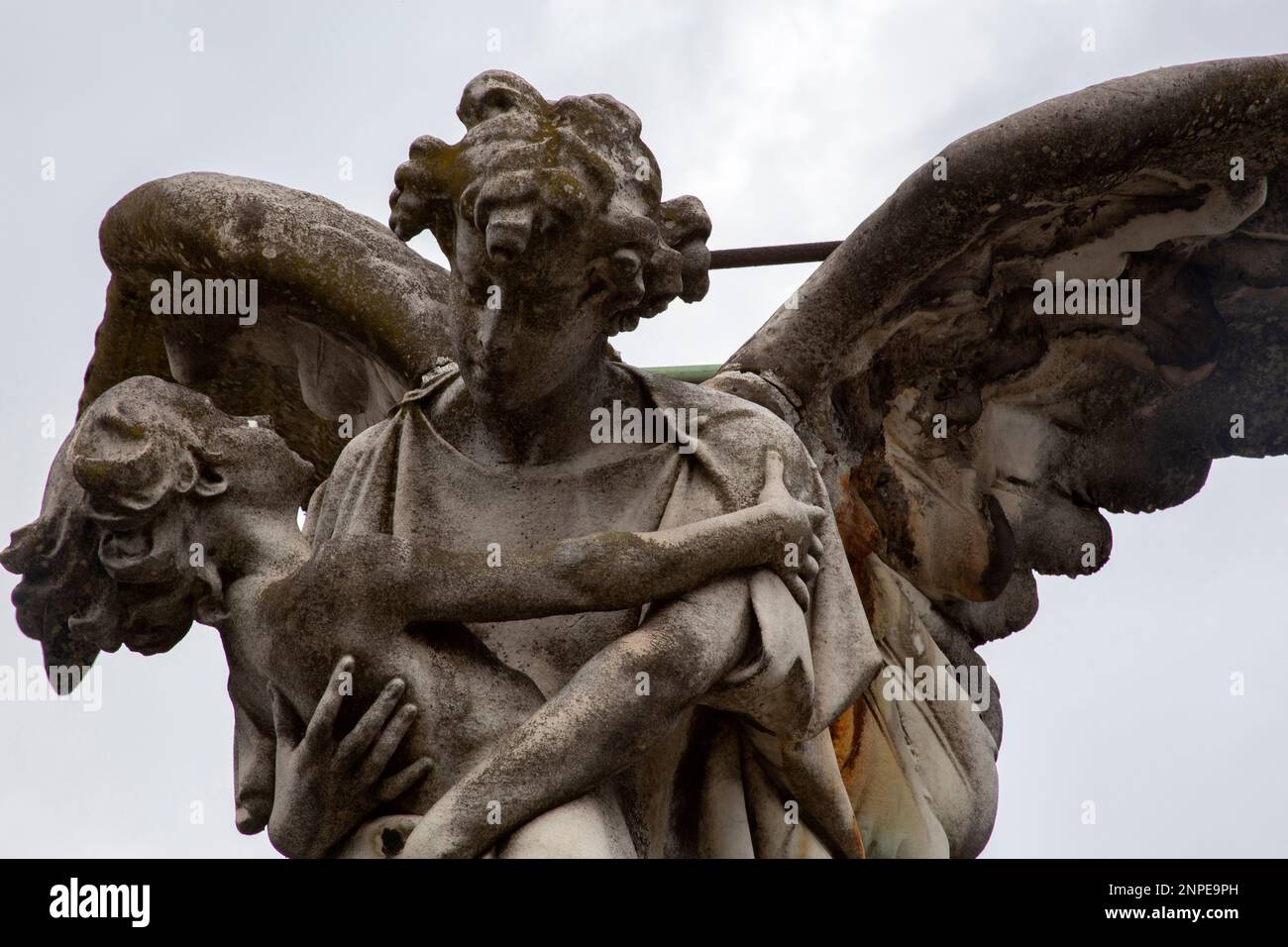 Angel holding a child, funerary sculpture in the Monumental Cemetery of ...