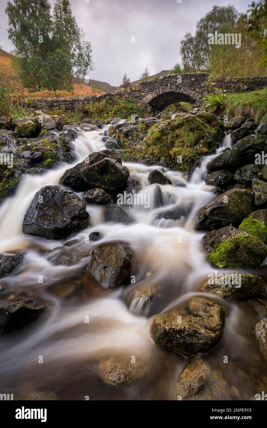 Water tumbling over rocks below Ashness Bridge in the Lake District ...