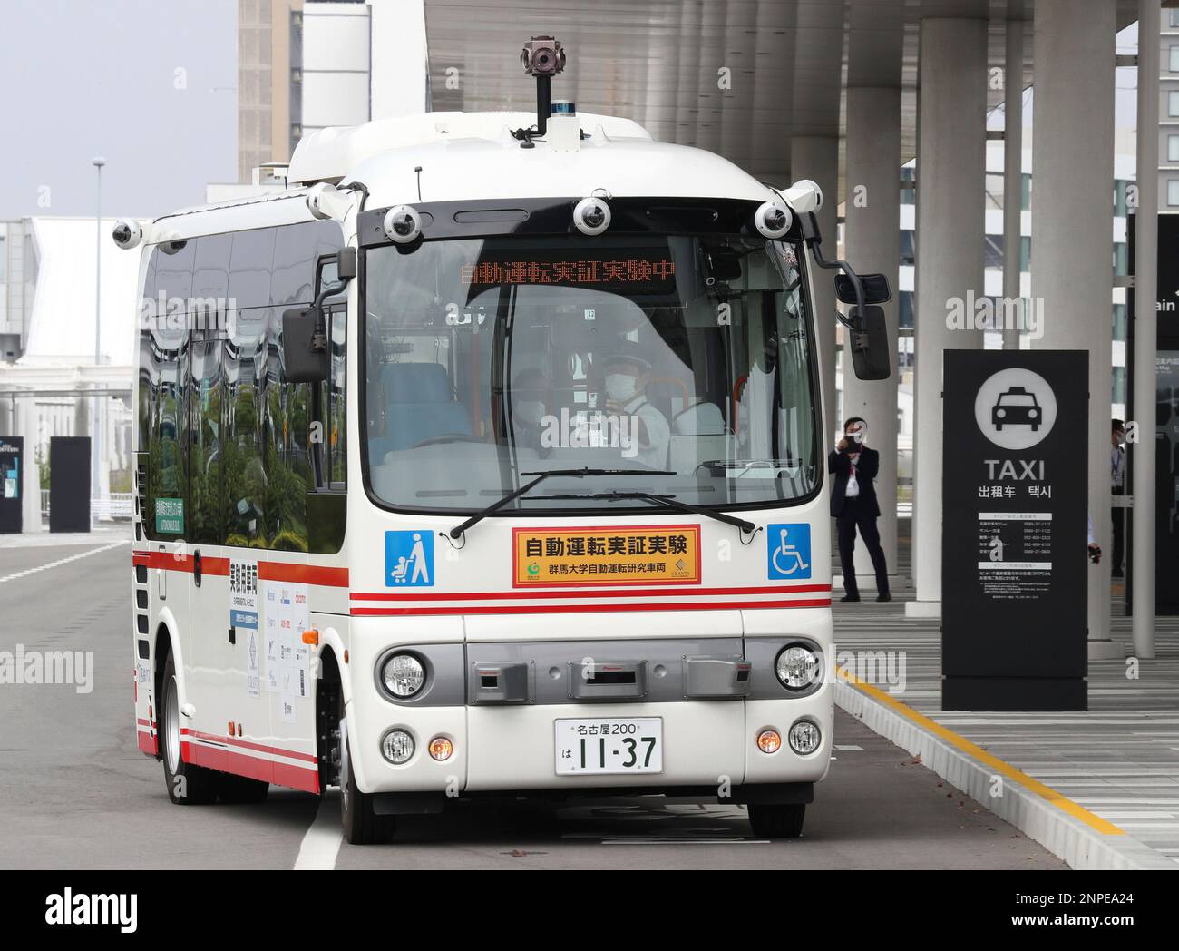 A self-driving small bus test is conducted as a driver remains unseated ...