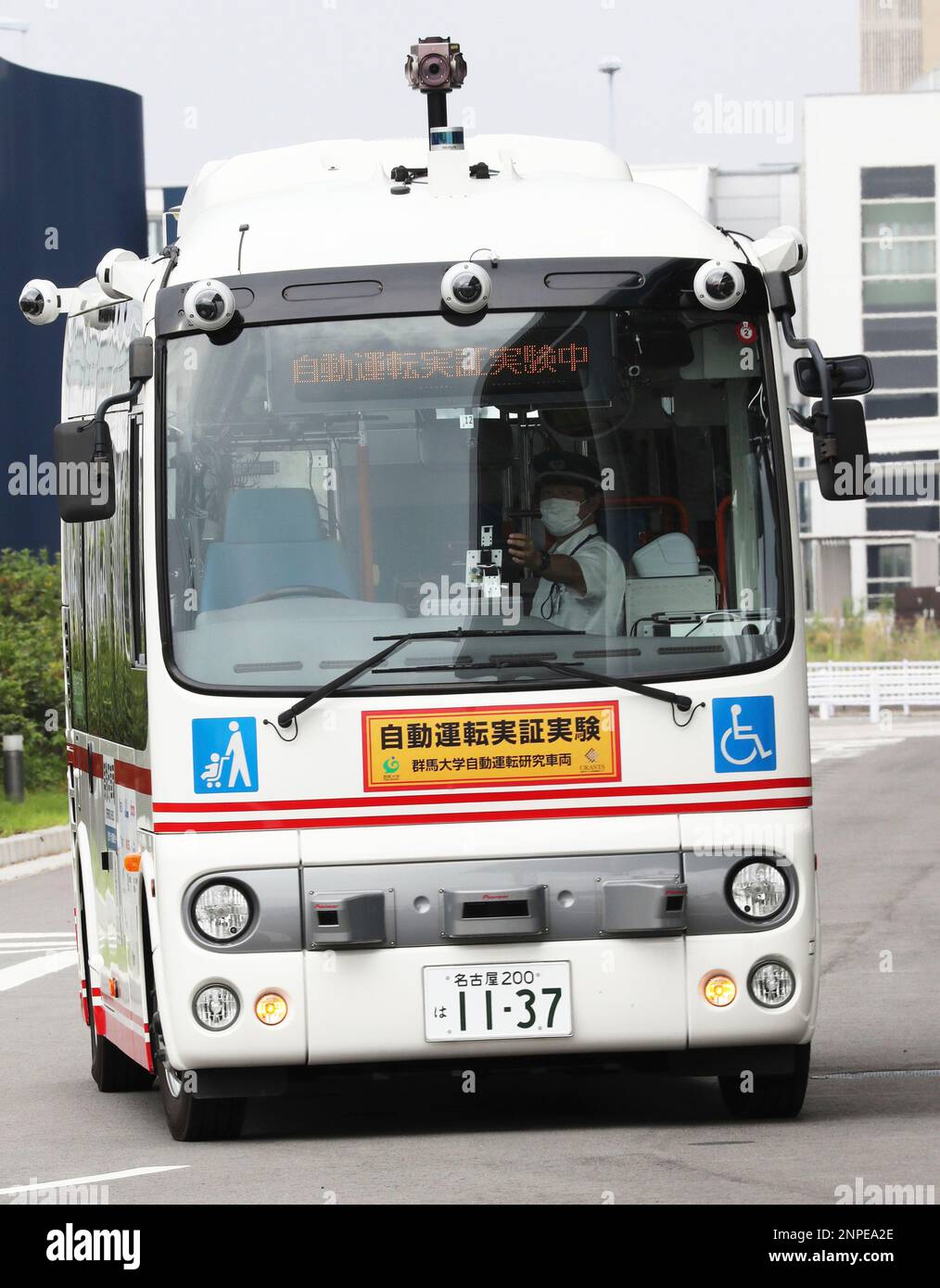 A self-driving small bus test is conducted as a driver remains unseated ...