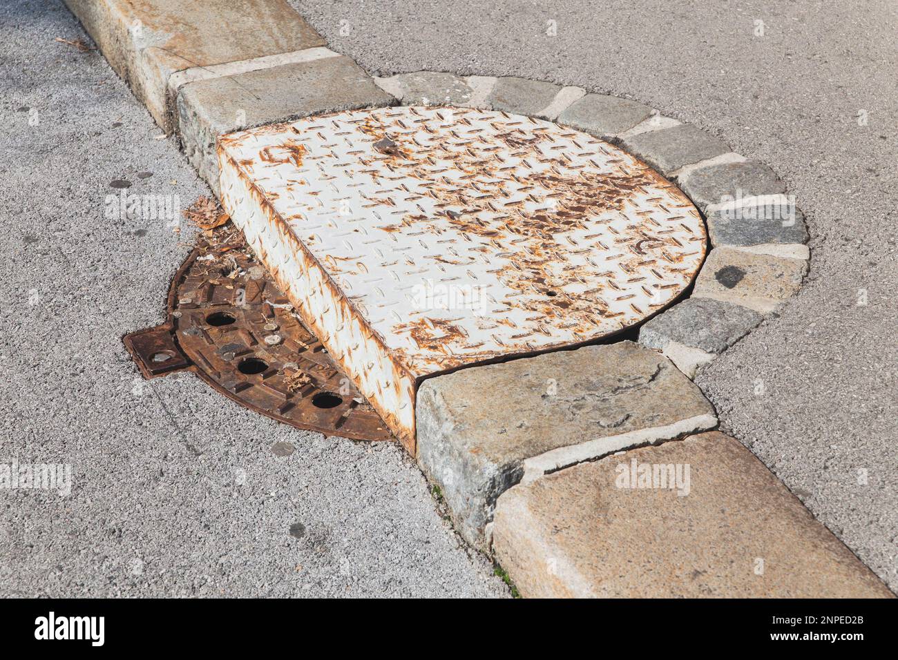 Unusual sewer hatch located on the road and the sidewalk in Slovenia ...
