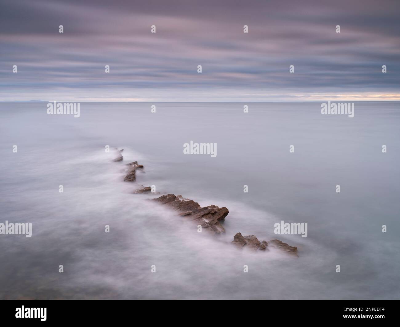 Waves washing off a rocky ledge at Peveril Point Stock Photo - Alamy