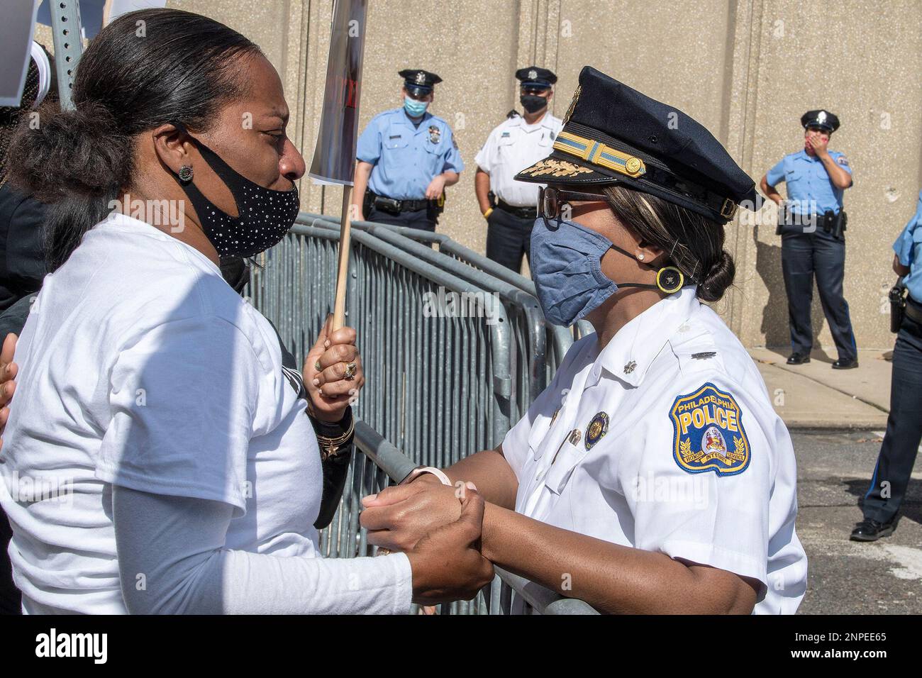 Kim Fabian, left, holds hands with Police Officer Altovise Love ...