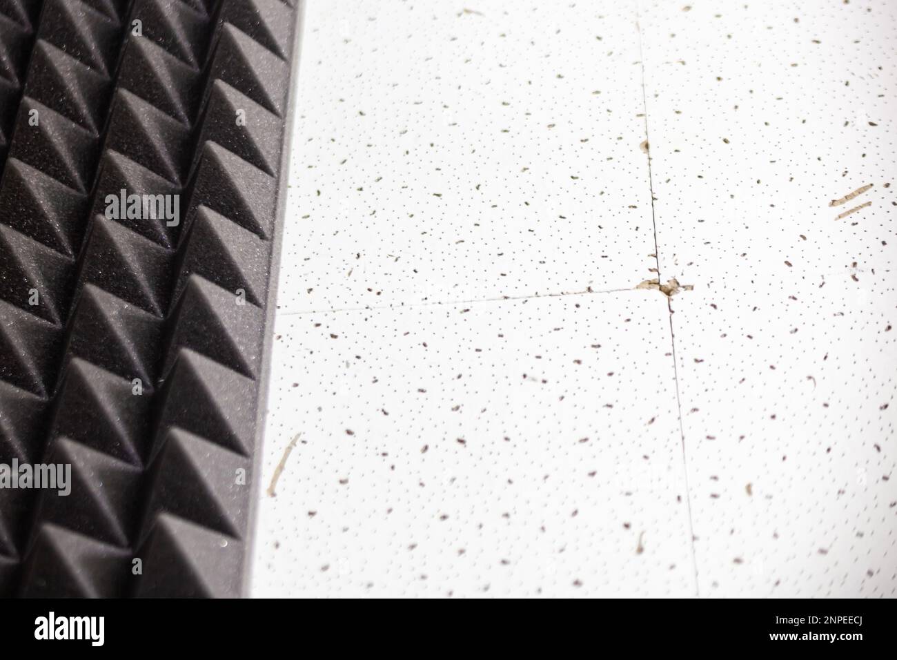 Two backgrounds on one wall. Professional soundproofing and plain white ...