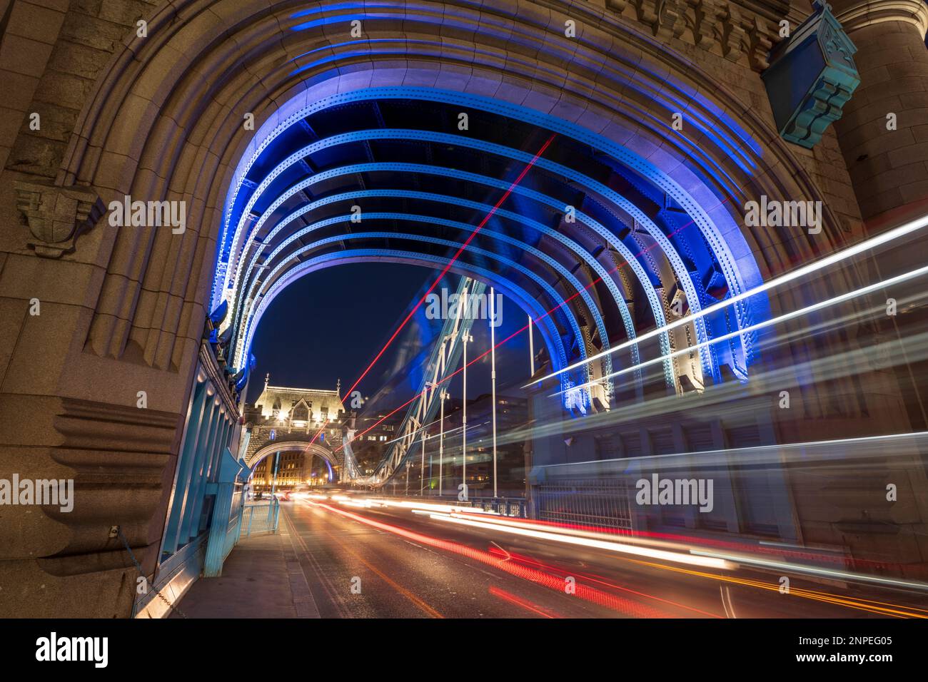 Traffic trails under one of the arches of Tower Bridge in London Stock ...