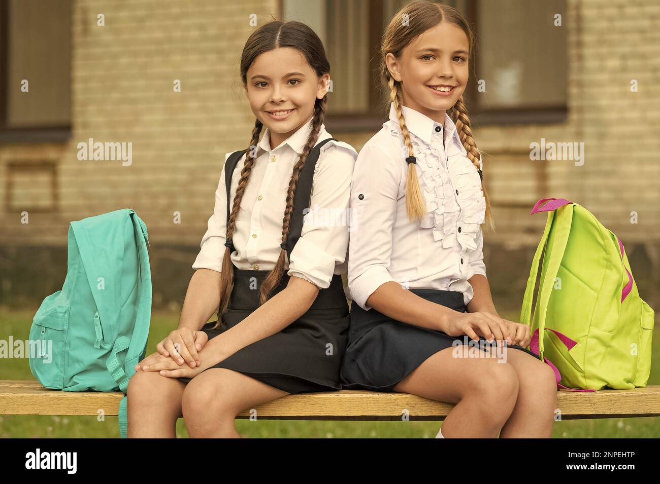 back to school. two happy teenager children after school outdoor ...