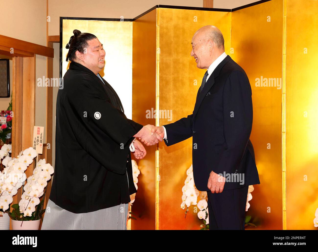 Shodai (L), newly promoted to Ozeki shakes hands with Katsuo Uchida ...