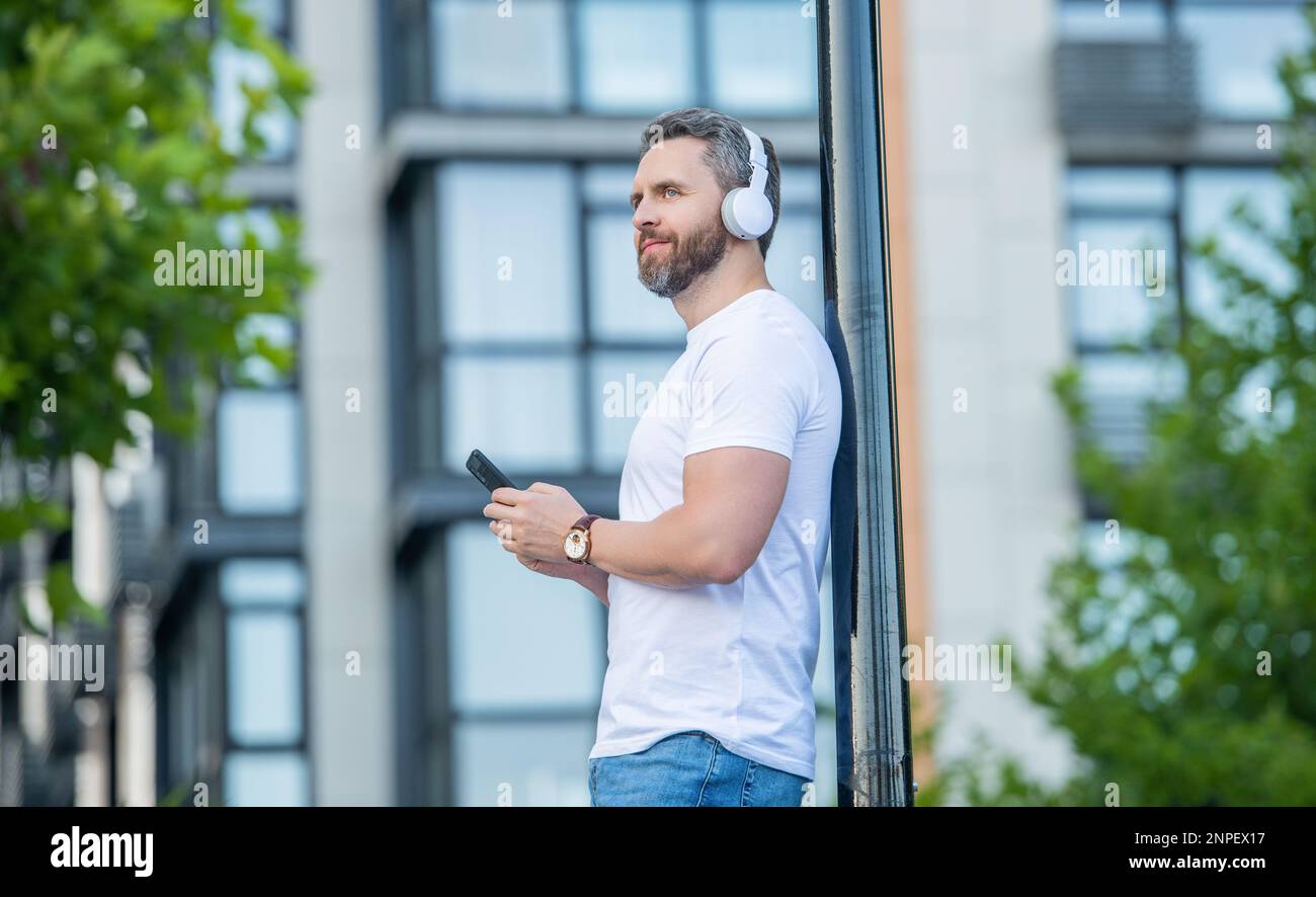 man choose music playlist in the street. man choosing music playlist ...