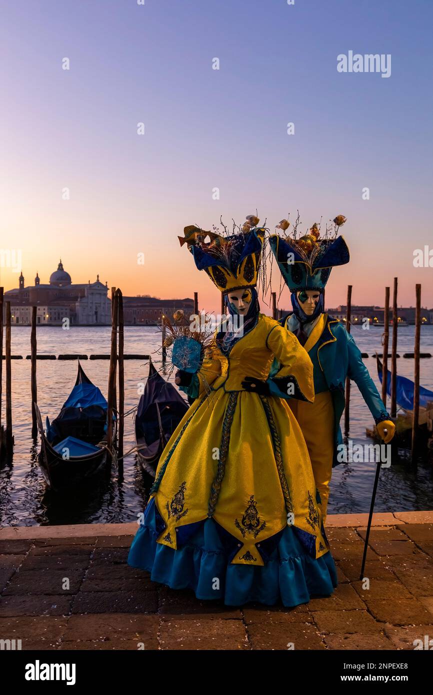 Carnival goers dressed in splendid costumes and masks during Venice ...
