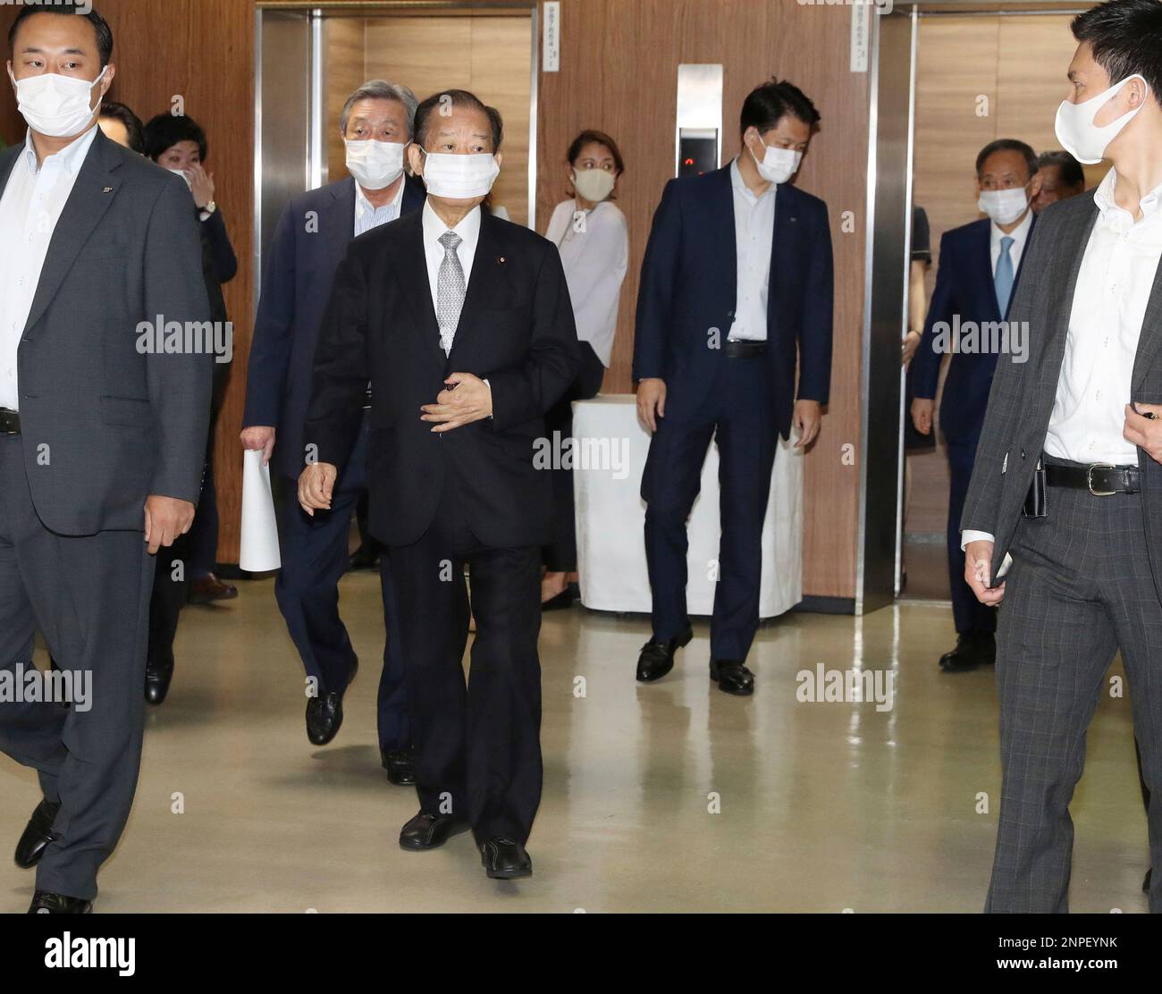 Japan's Prime Minister Yoshihide Suga (right rear) , Secretary-General ...