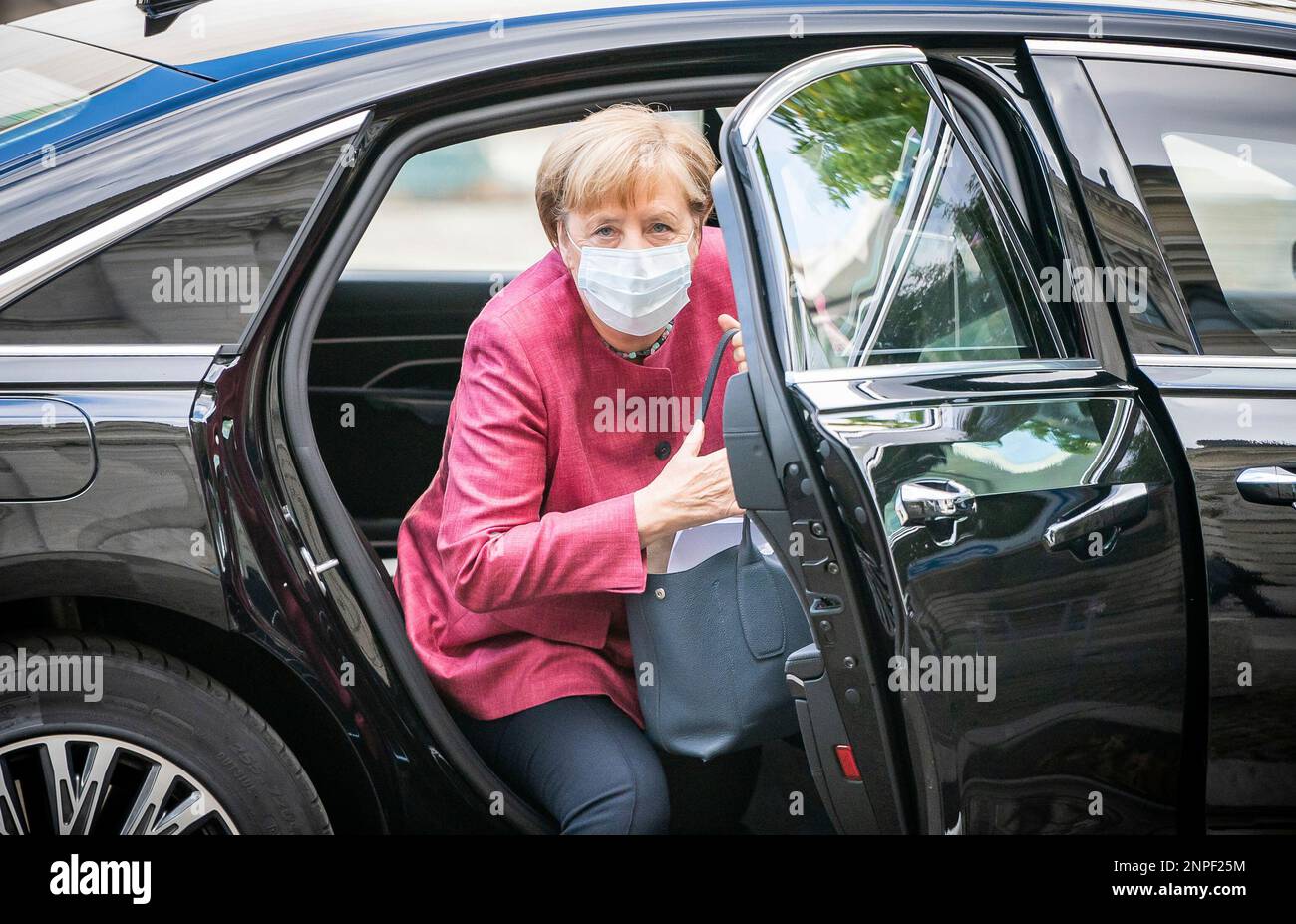 German Chancellor Angela Merkel wears a face mask as she arrives at the ...