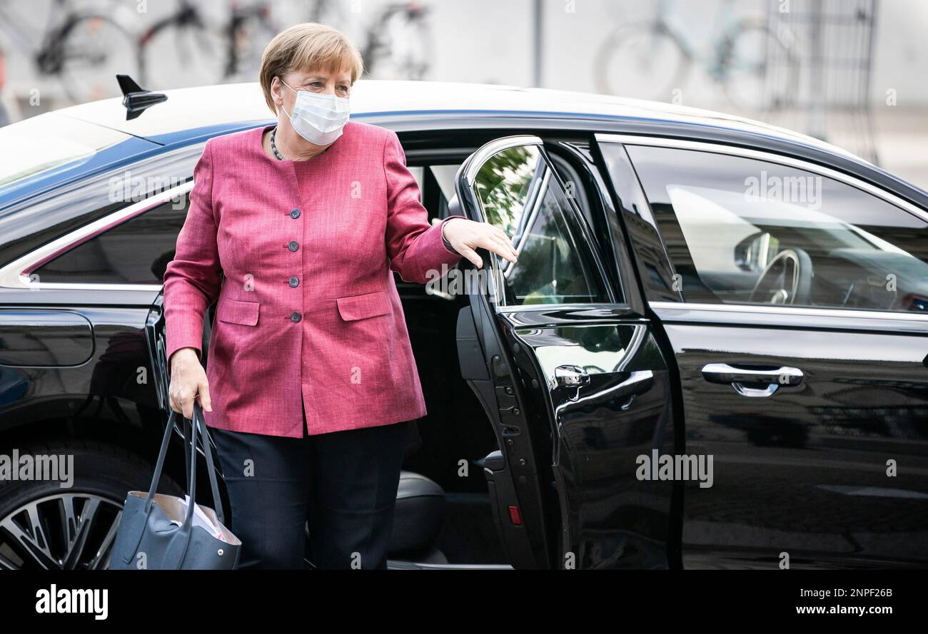 German Chancellor Angela Merkel wears a face mask as she arrives at the ...
