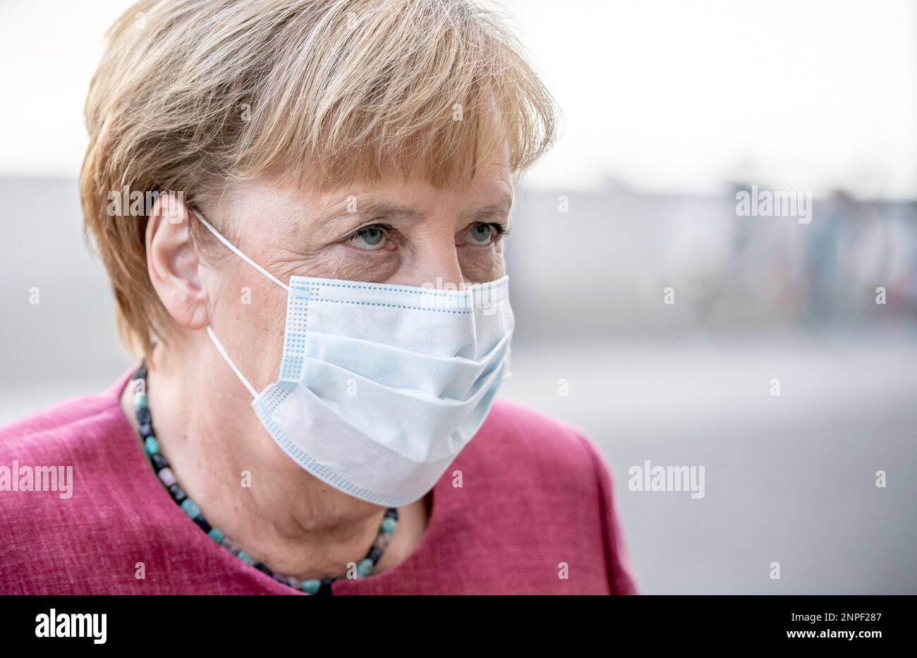 German Chancellor Angela Merkel wears a face mask as she arrives at the ...