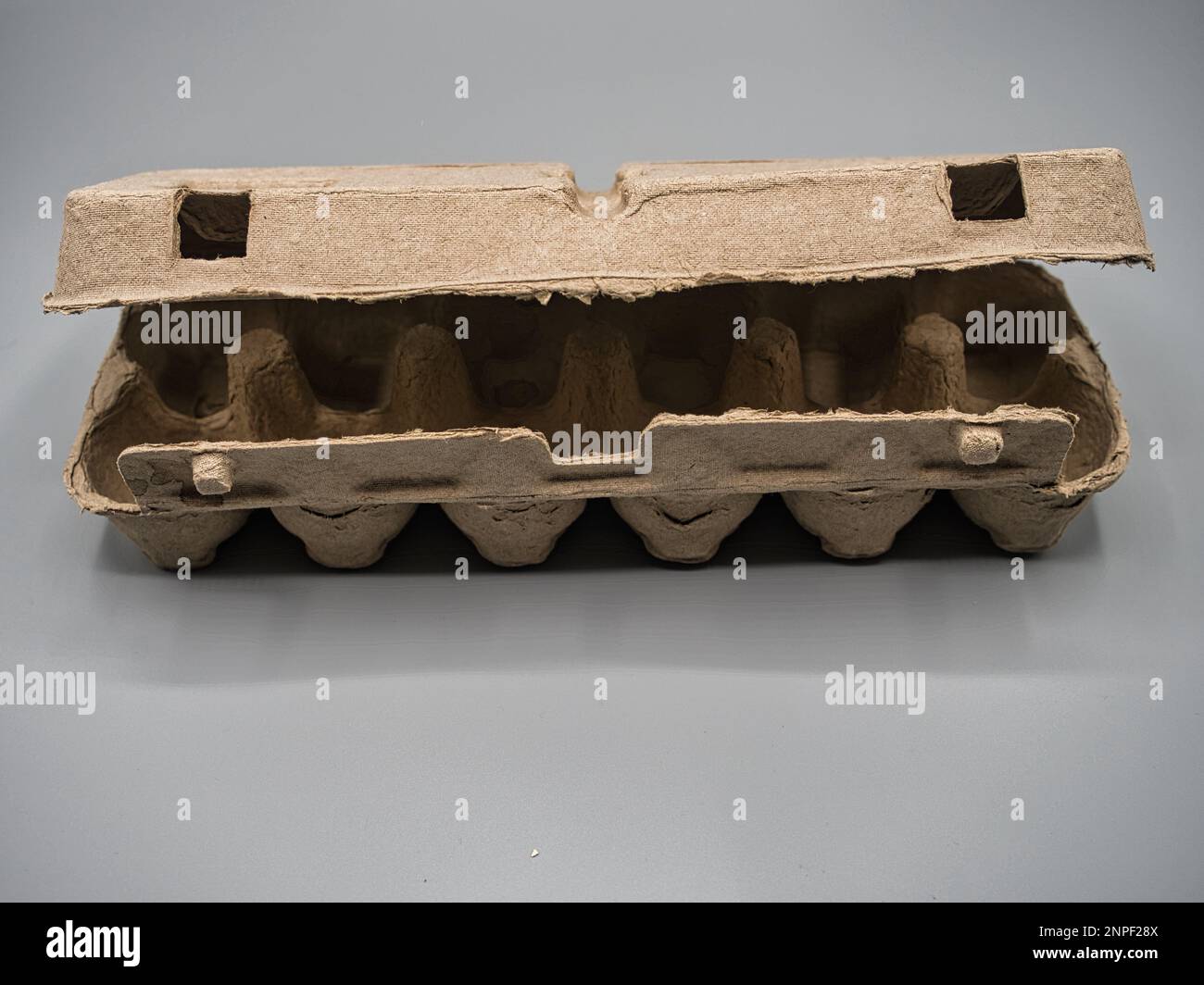 Plain brown empty egg container on simple gray background Stock Photo ...