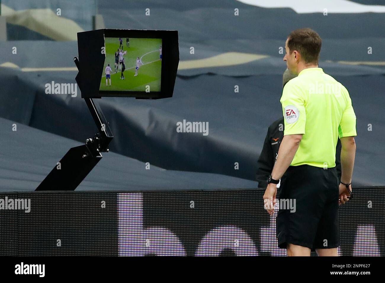 Referee Peter Bankes watches a monitor during the English Premier ...