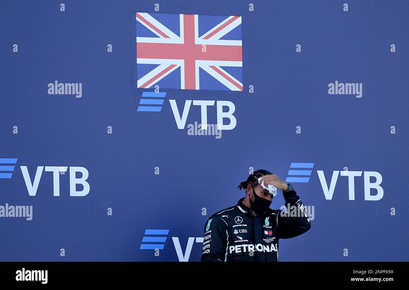 Mercedes driver Lewis Hamilton of Britain wipes his forehead as he ...