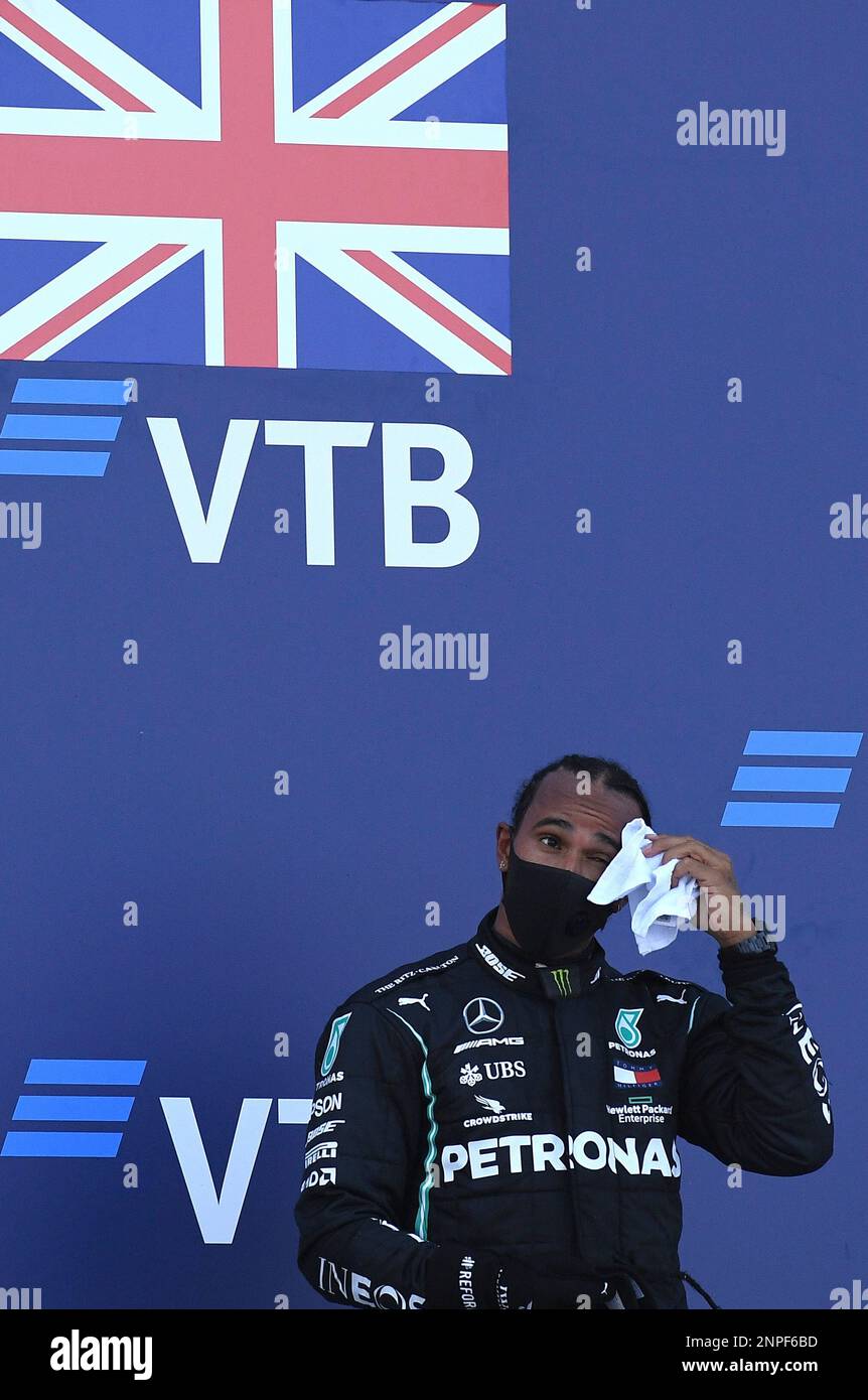 Mercedes driver Lewis Hamilton of Britain wipes his forehead as he ...