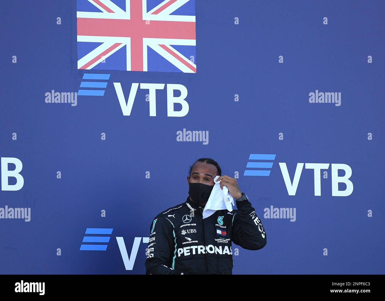 Mercedes driver Lewis Hamilton of Britain wipes his forehead as he ...