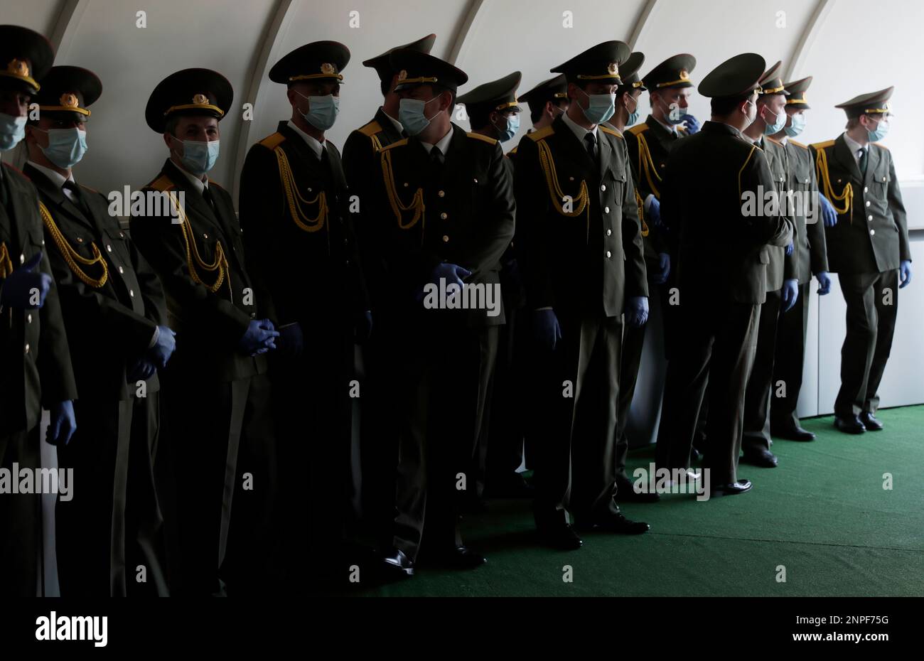 Members of the Russian Military Corps wear protective masks and gloves ...