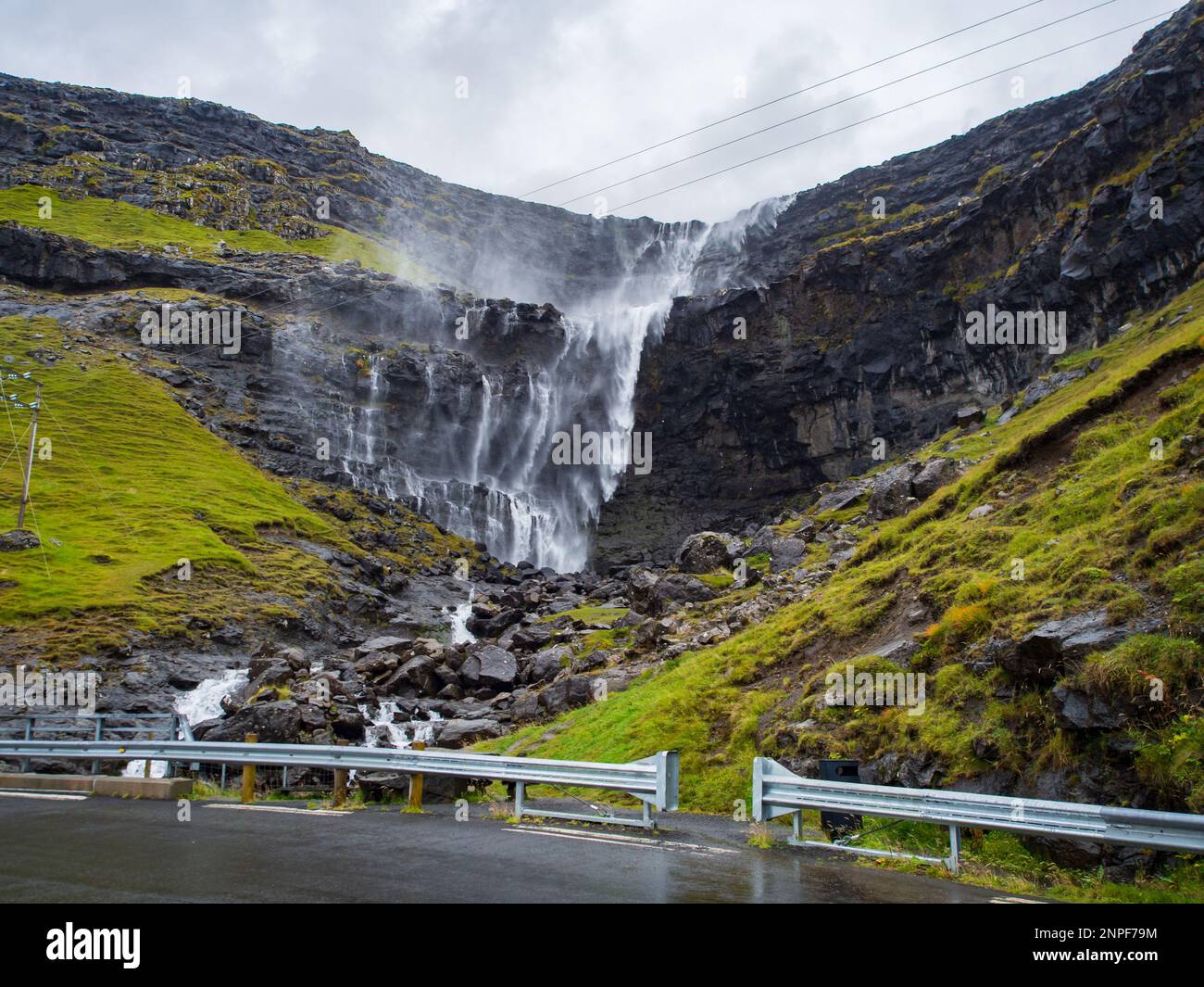 Waterfall Fossa (Fossá) during strong wind in rainy weather, Streymoy ...