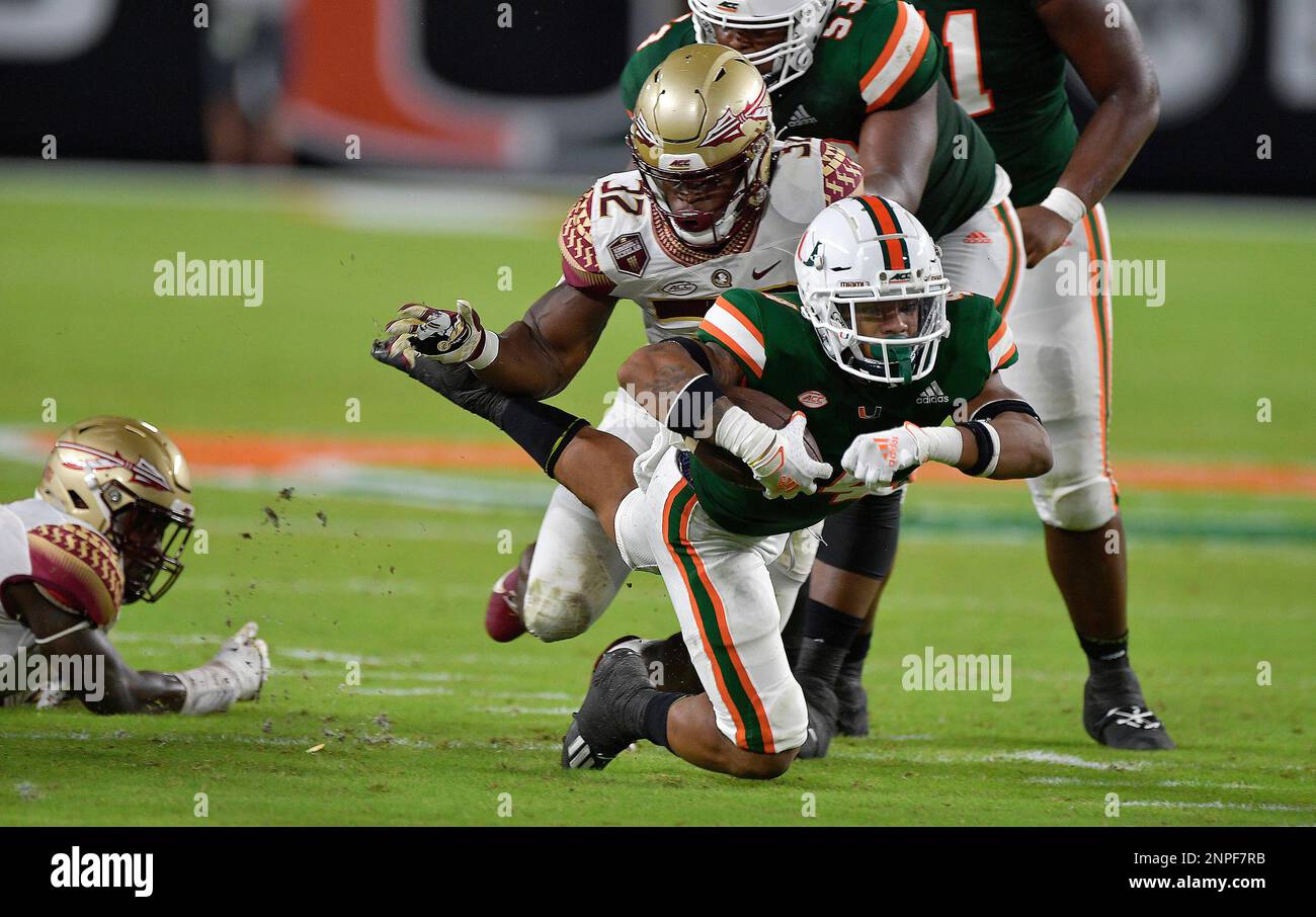 Miami running back Jaylan Knighton dives for an extra yard against ...