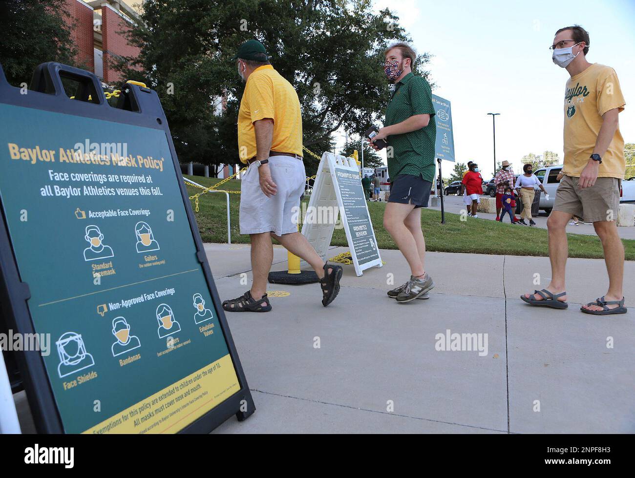 Baylor fans wear face masks as the enter McLane stadium for Baylor's ...