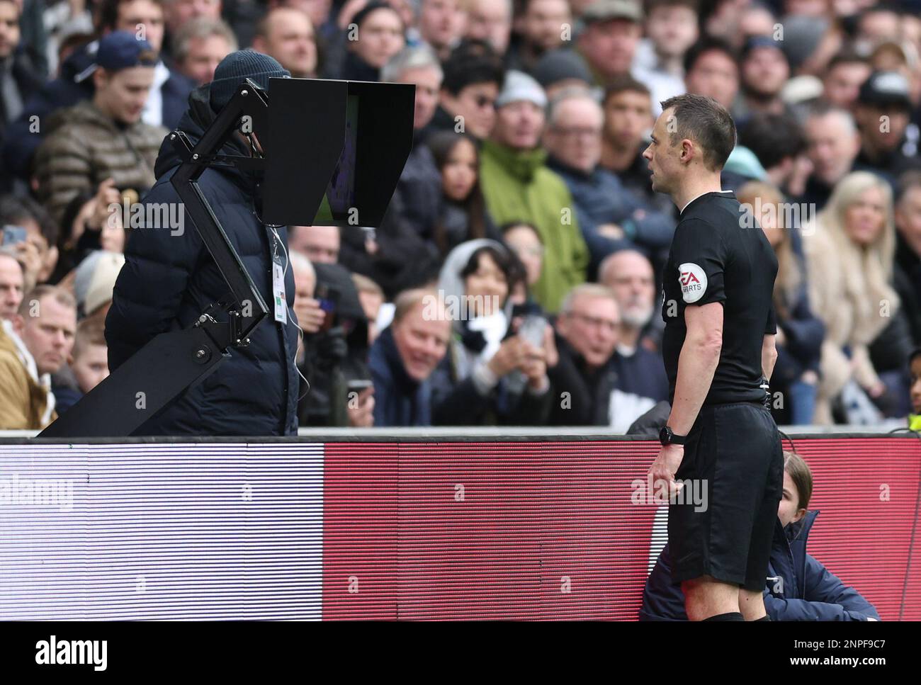 London, UK. 26th Feb, 2023. Referee Stuart Attwell checks the VAR ...