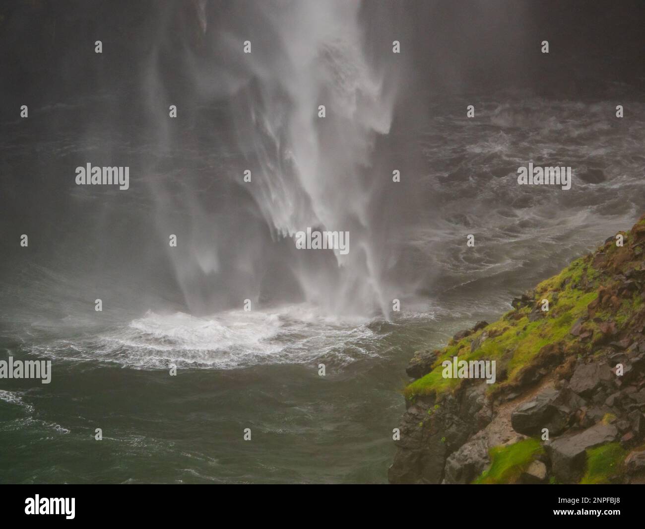 Close uo for waterfall Gasadalur falling into the ocean during strong ...