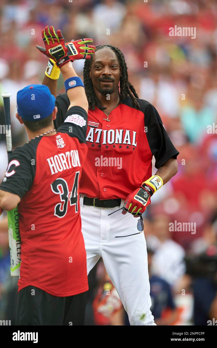 Rapper Snoop Dogg high fives Wounded Warrior Tim Horton (34) during the ...