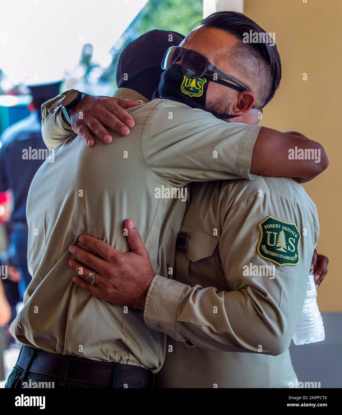 Forest Service firefighters hug after the attending a memorial for ...